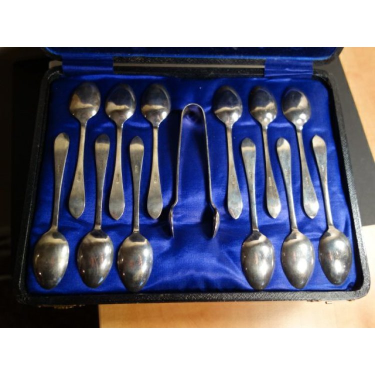 12 vintage silver plated tea spoons and sugar tongs.